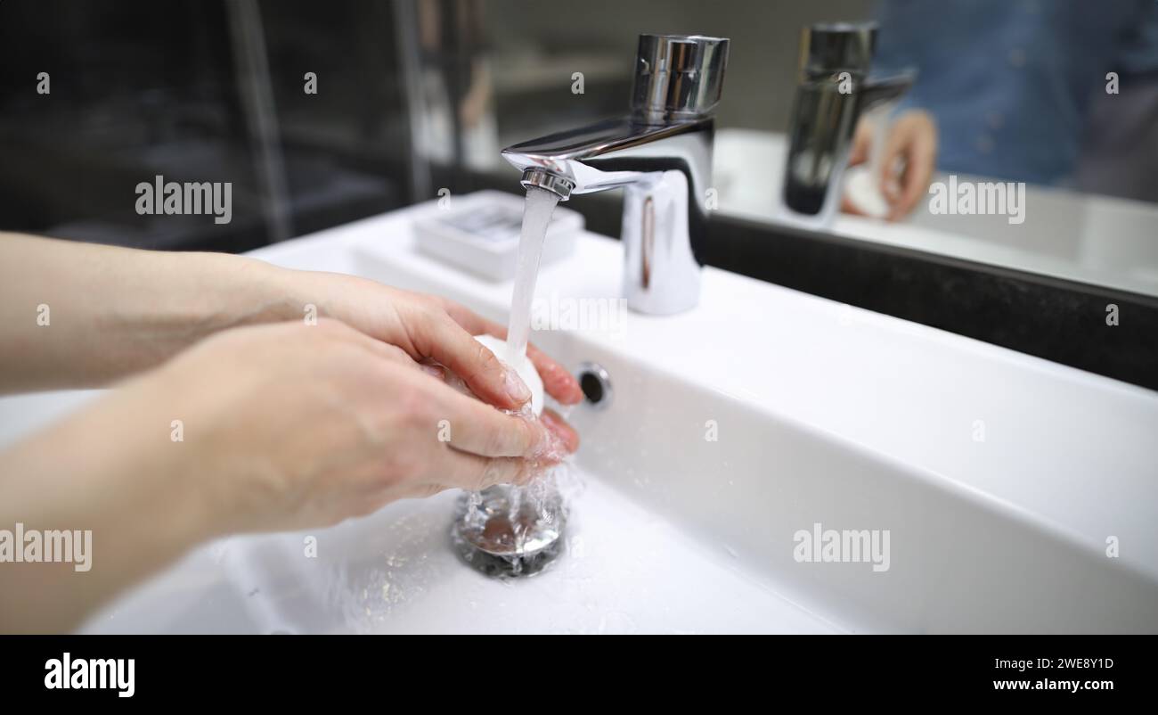 Man thoroughly washes his hands with soap under tap Stock Photo - Alamy