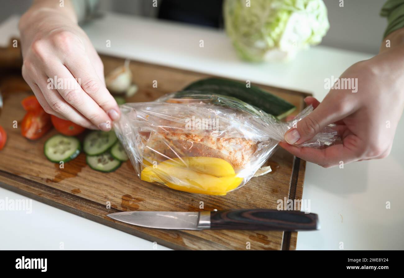 Hands put in sleeve for baking meat and vegetables Stock Photo - Alamy
