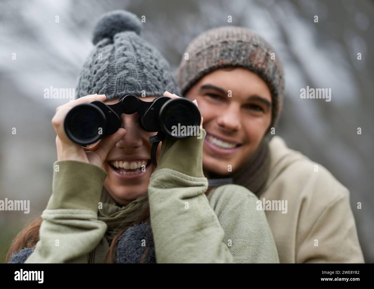 Binoculars, nature and happy couple in portrait for journey, adventure ...