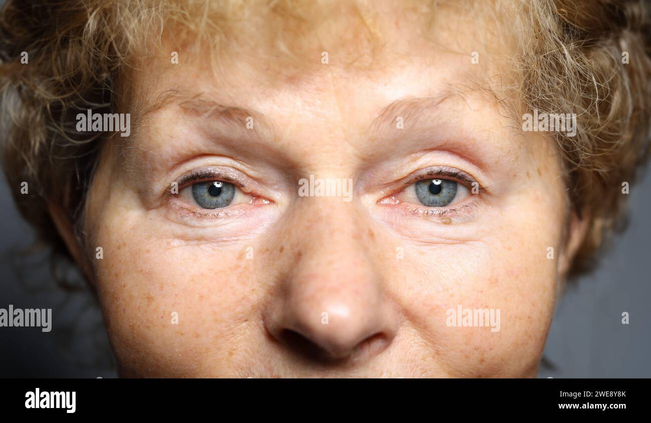 Tired look an elderly woman European appearance Stock Photo - Alamy
