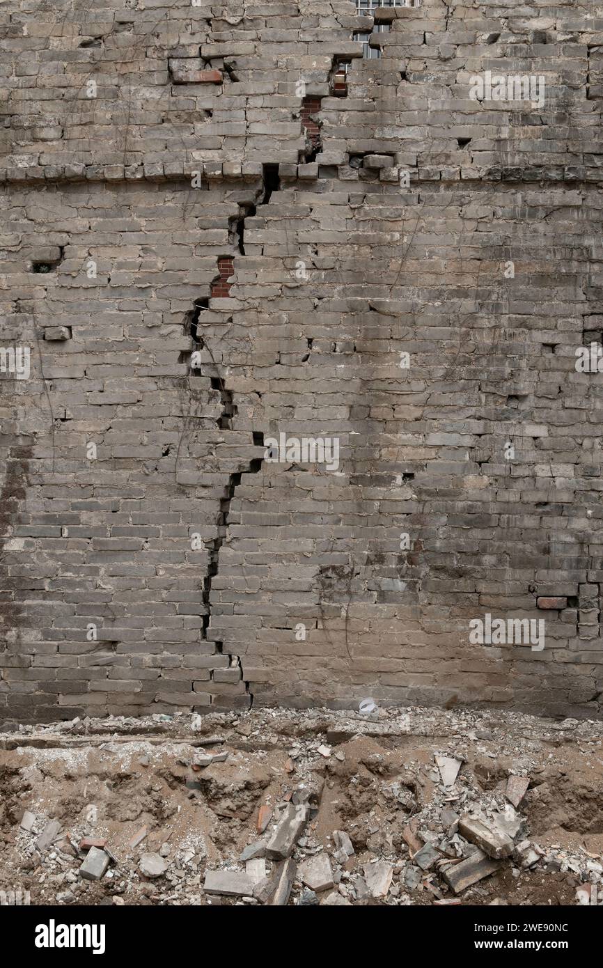 a dangerous wall with large cracks at vertical composition Stock Photo ...