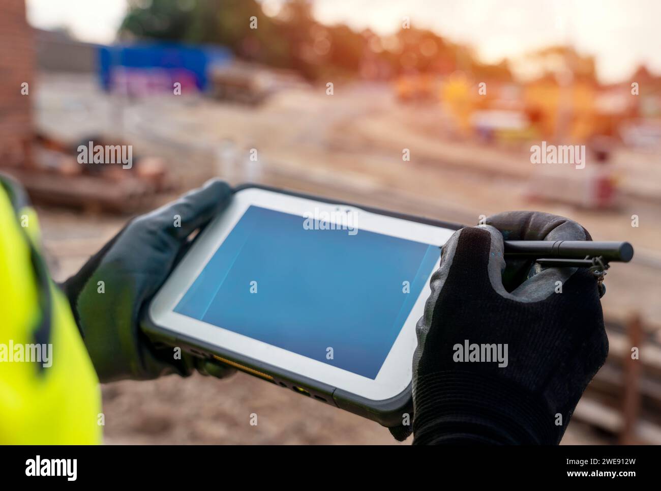 Site engineer surveyor using rugged tablet controller computer to ...