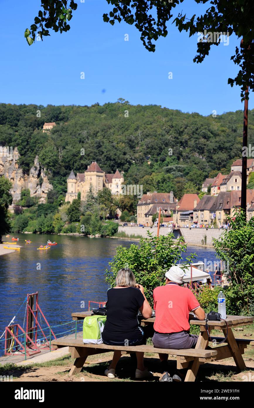 Picnic by the river in one of the most beautiful villages. Couple ...