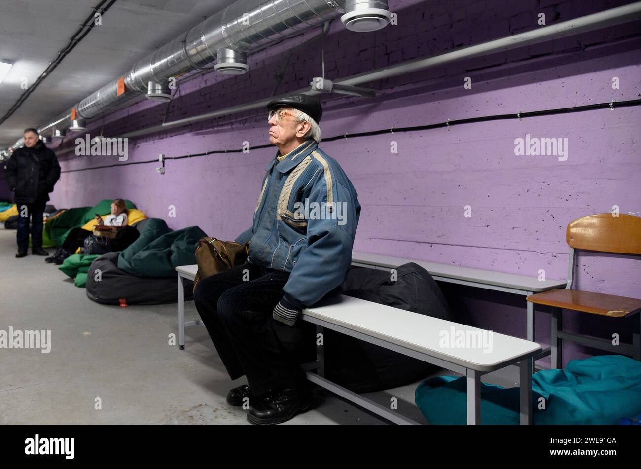 KYIV, UKRAINE - JANUARY 23, 2024 - A man sits on the bench in the bomb ...