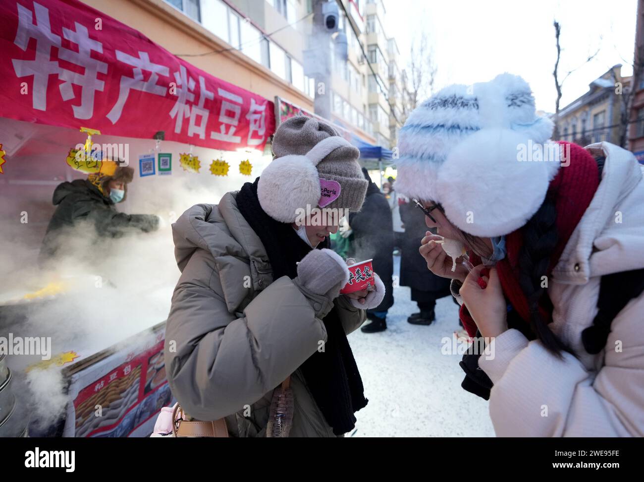 Harbin, China's Heilongjiang Province. 22nd Jan, 2024. Tourists taste ...
