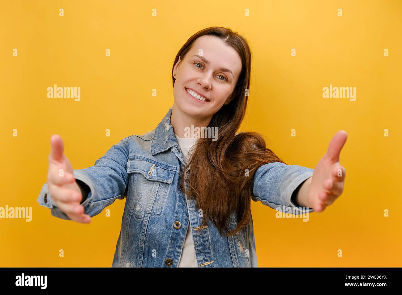 Portrait of smiling pretty young woman 25s outstretching hands to ...