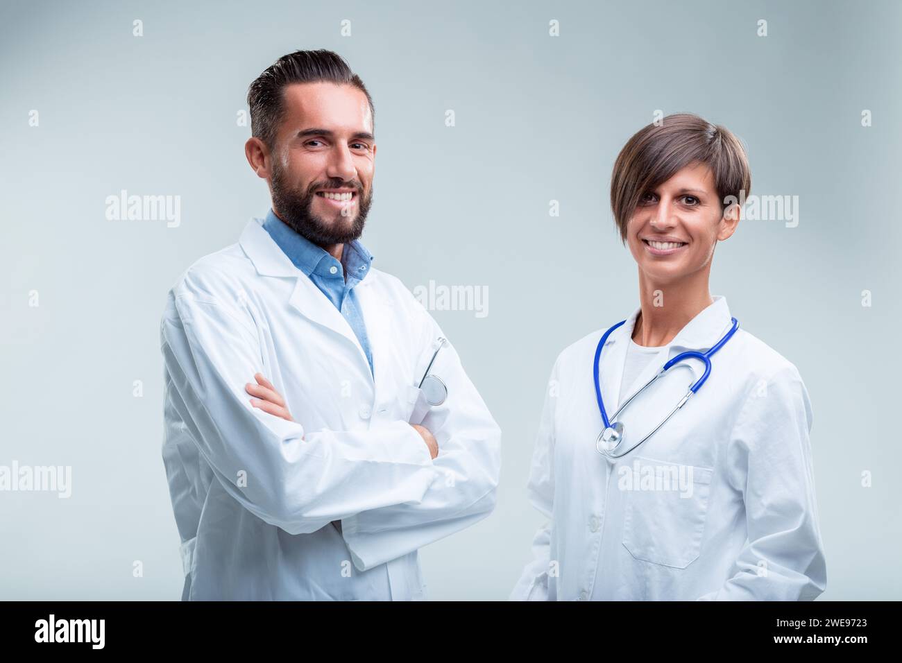 Medical team members stand proudly, their professional attire and ...