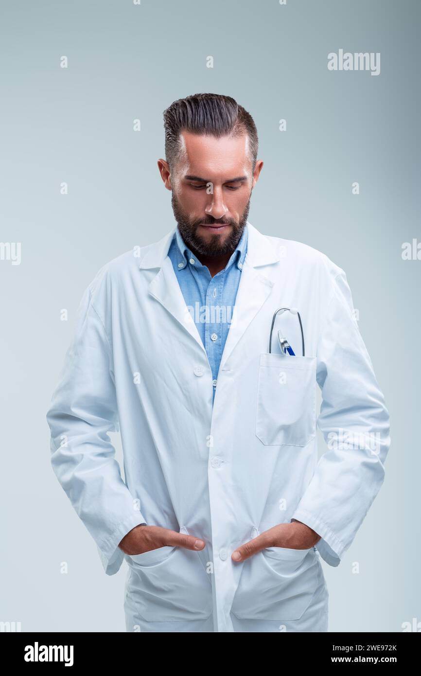 Concerned medical professional contemplates a serious issue, hands on ...