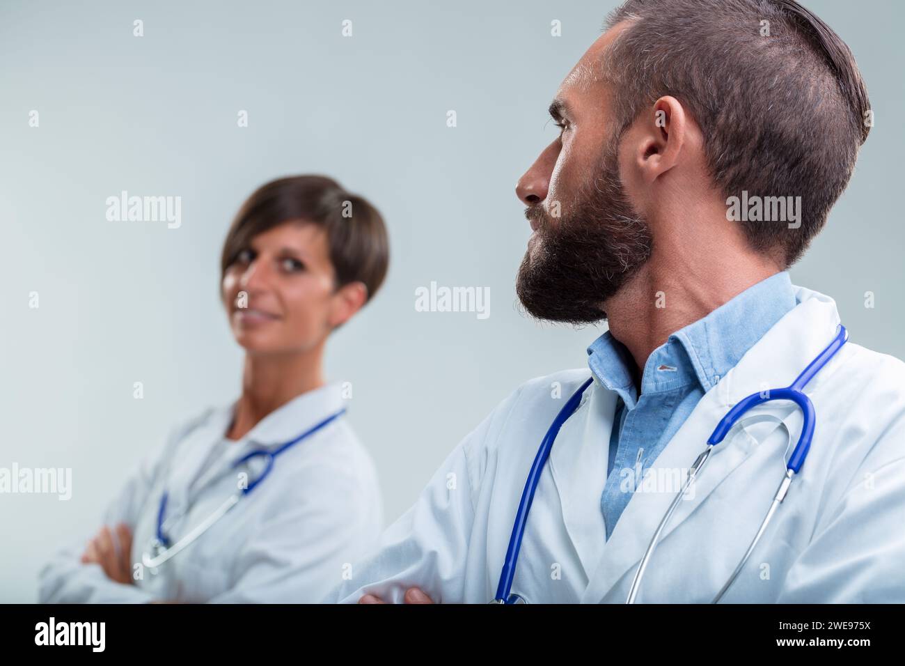 Two doctors, one pondering and one reassuring, capture the essence of ...