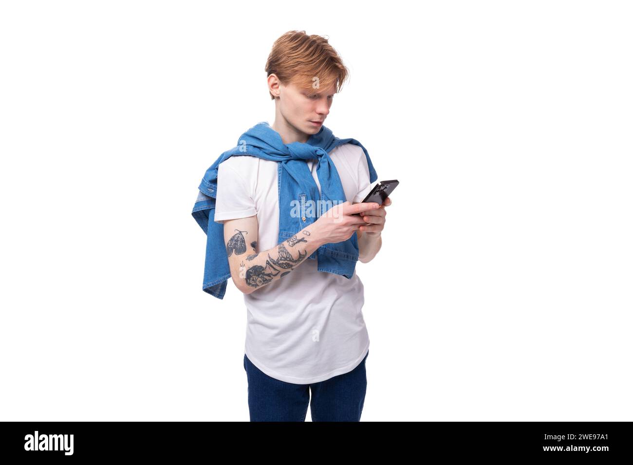 young emotional handsome slender red-haired man with a tattoo on his ...
