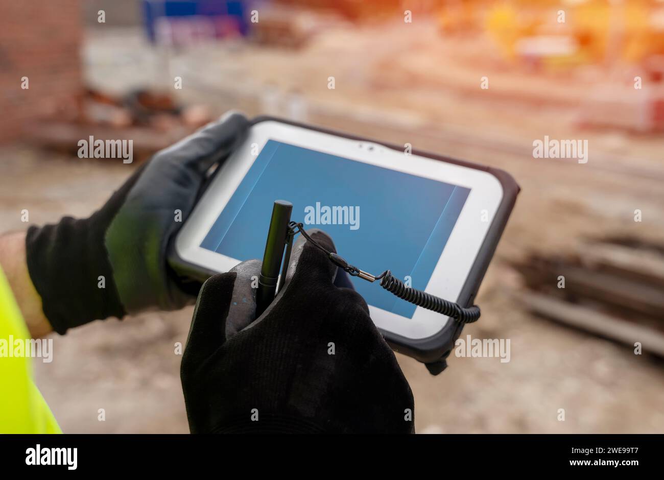 Site engineer surveyor using rugged tablet controller computer to ...