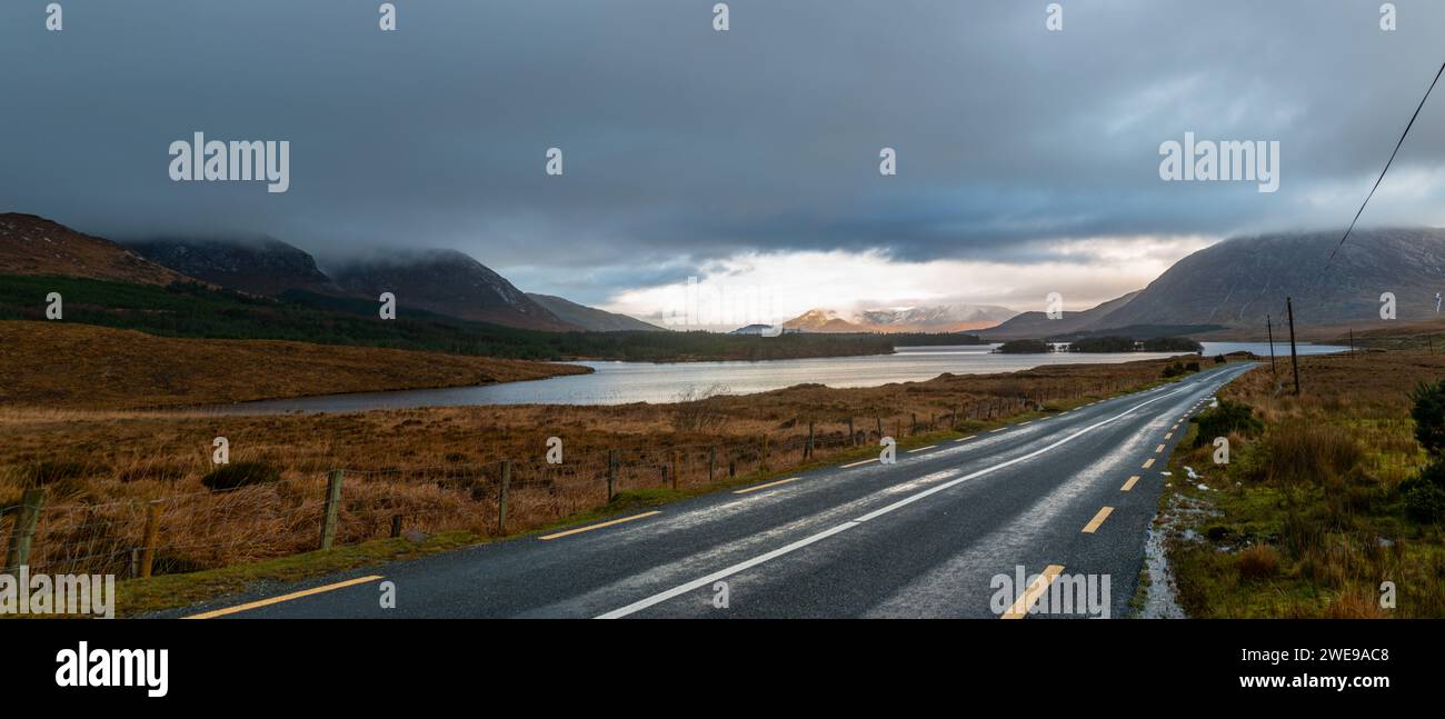 Panoramic view of an empty road leading through a dramatic landscape ...