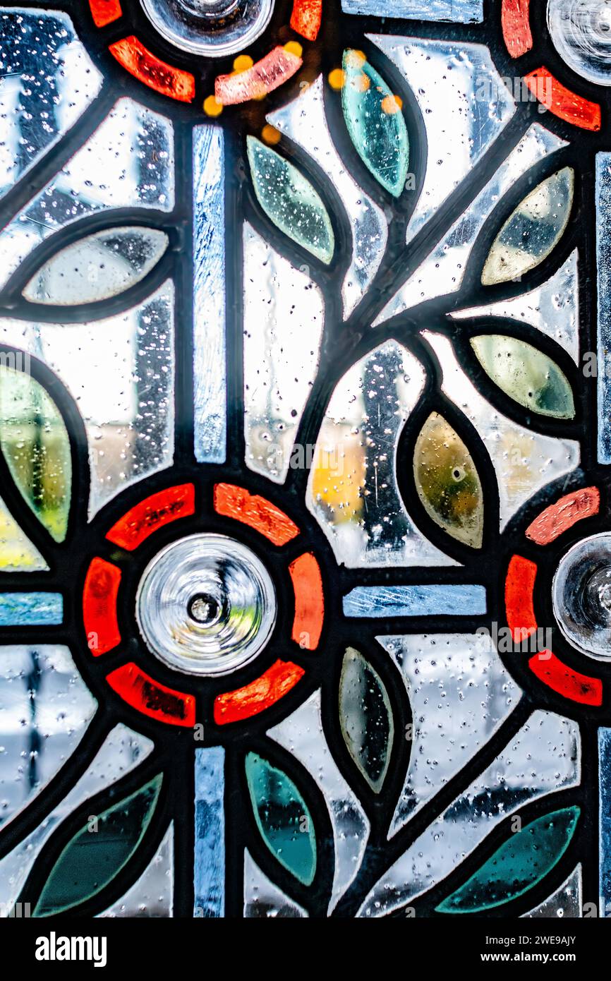 Colorful stained glass window with floral design, capturing light and ...