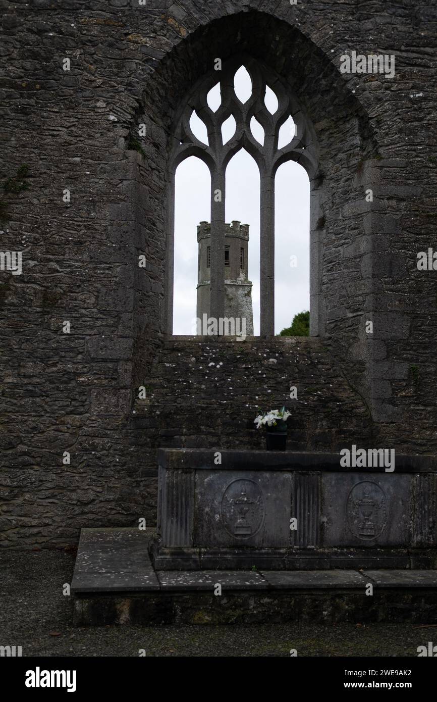 Medieval stone church ruins with gothic window and tombstone, moody ...