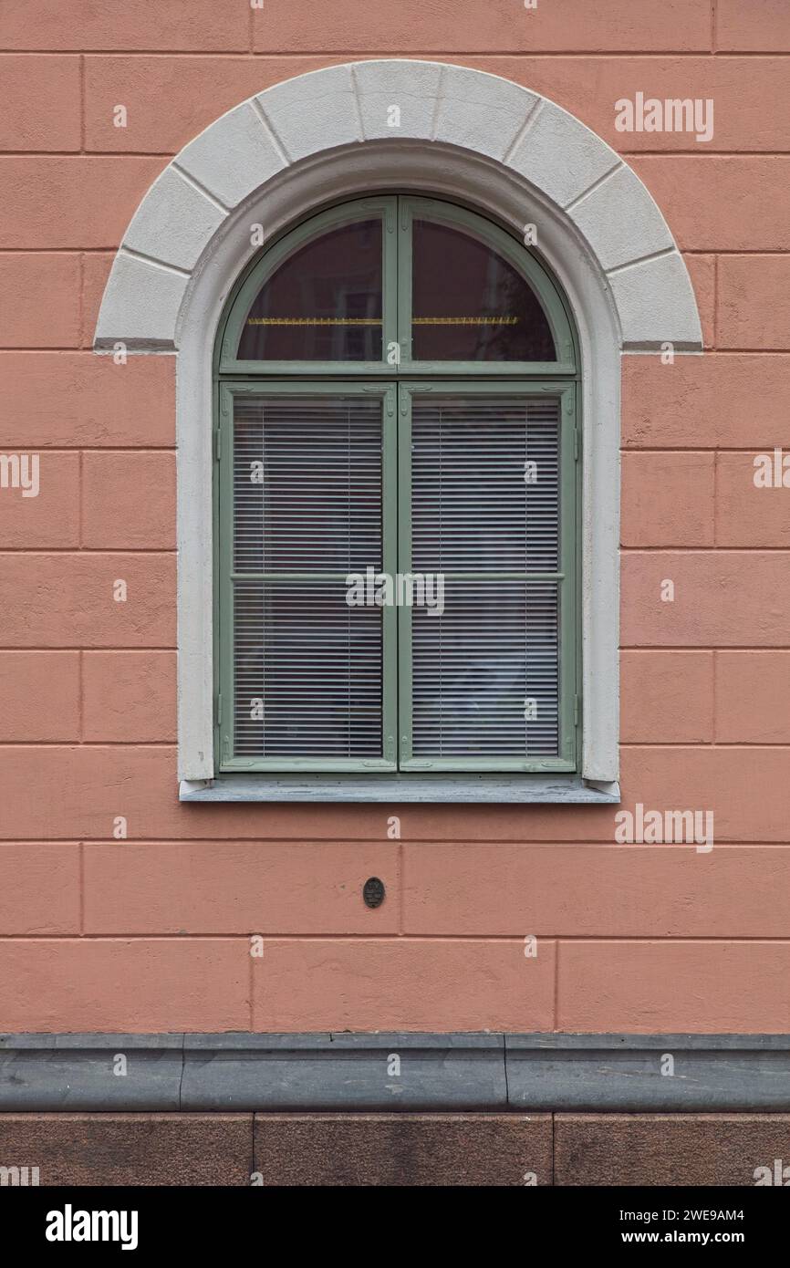 Pink stone building with arch window Stock Photo - Alamy