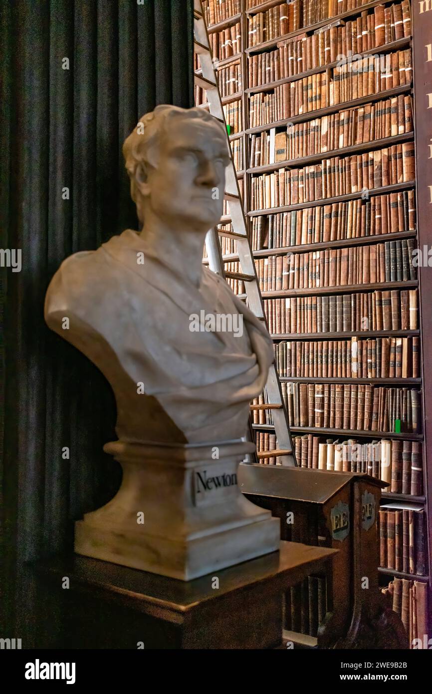 Marble bust of Isaac Newton in a classic library setting with ...