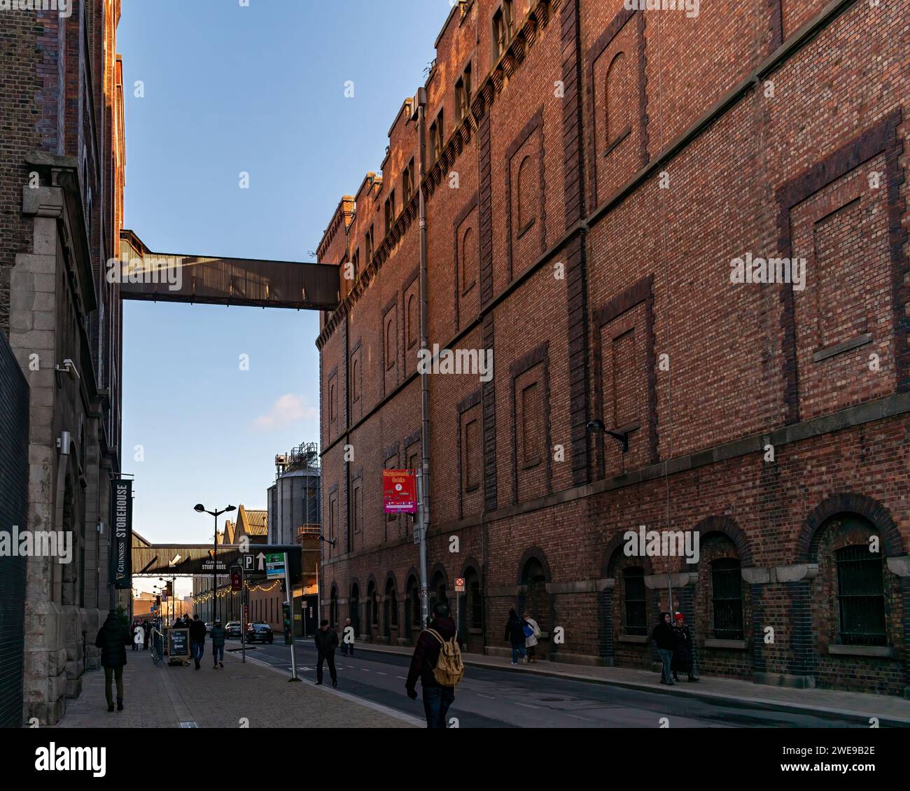 Urban street scene with pedestrians and historic red brick buildings ...