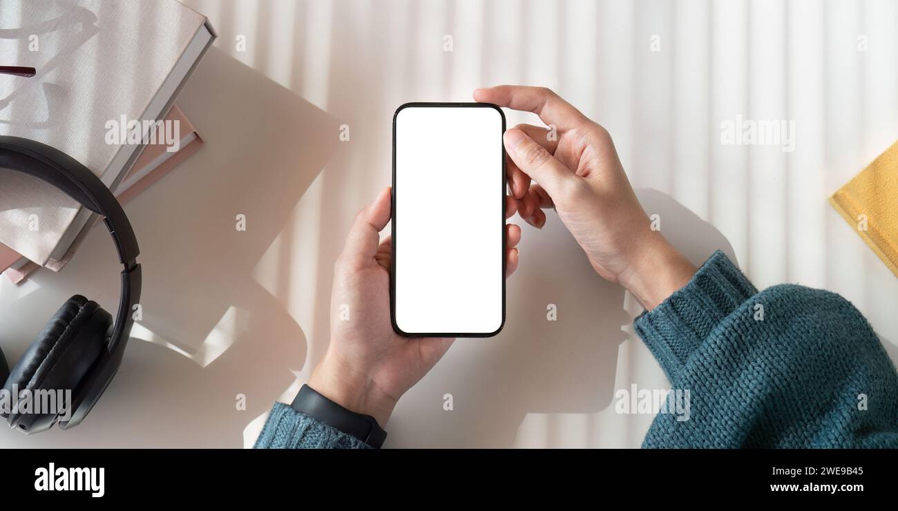 Top view mockup image of a woman holding mobile phone with blank white ...