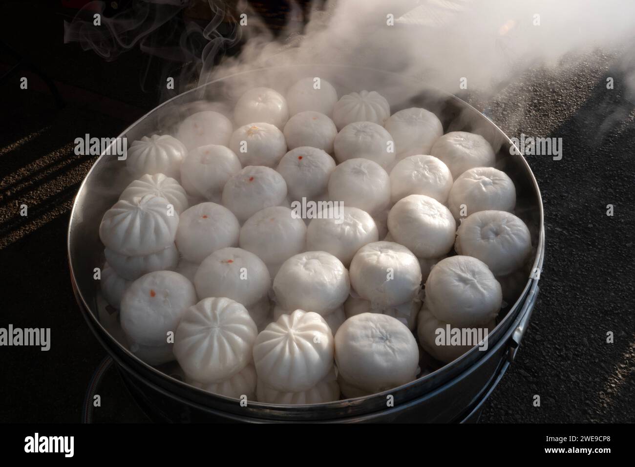 The steamed stuffed bun in the steamer in nature background Stock Photo ...