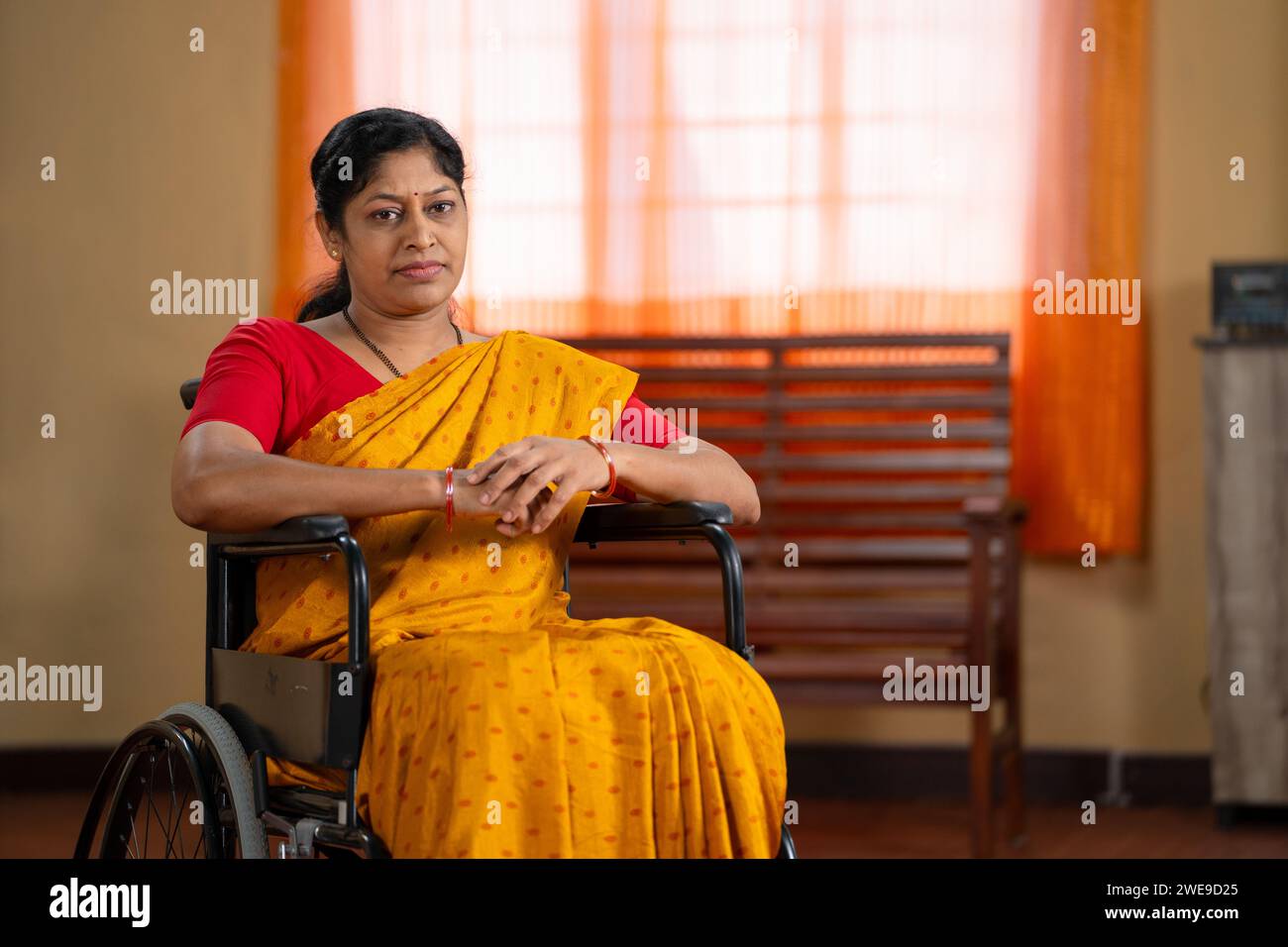 Alone Indian thoughtful senior woman with disability sitting on ...