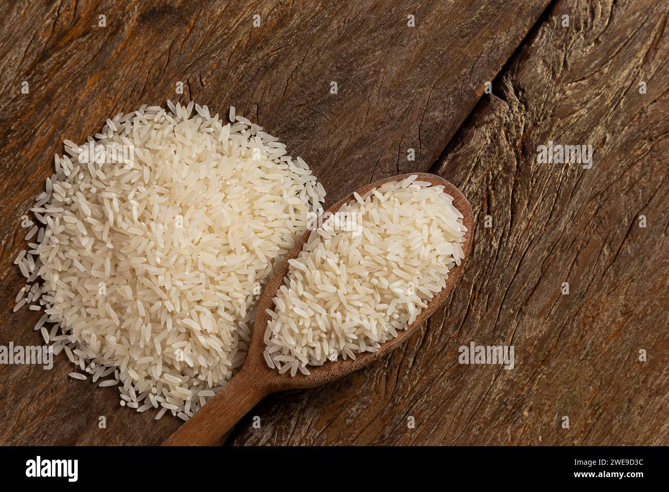 Raw white rice in a ceramic bowl on brown wooden background Stock Photo ...