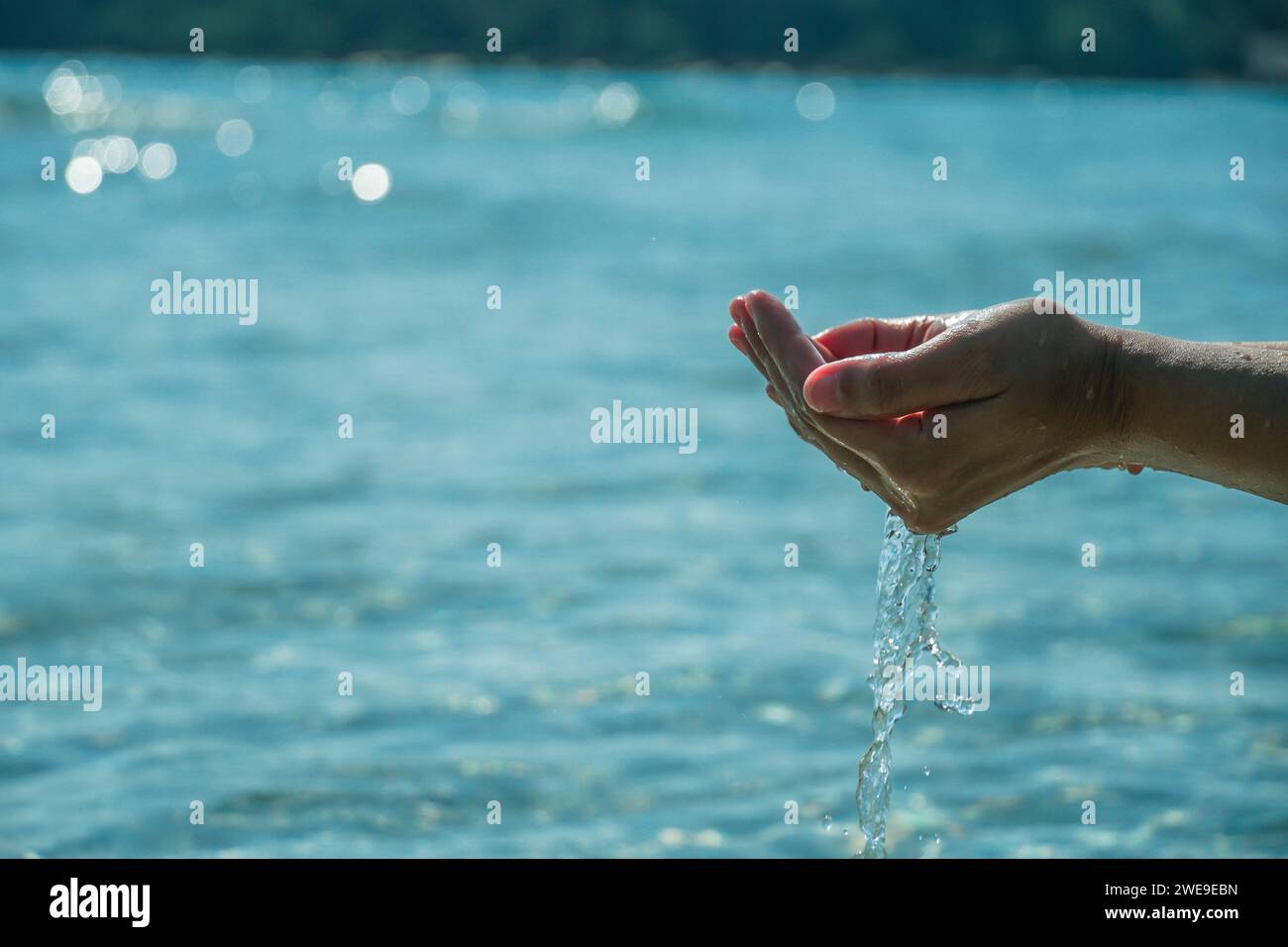 Hands with pure water. Holding water in cupped hands. Closeup of a ...