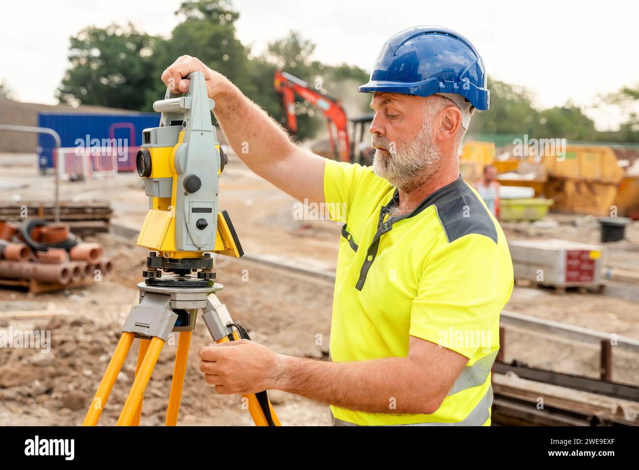 A man site engineer surveyor working with theodolite total station EDM ...