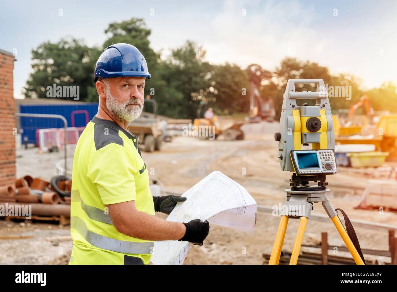 A man site engineer surveyor working with theodolite total station EDM ...