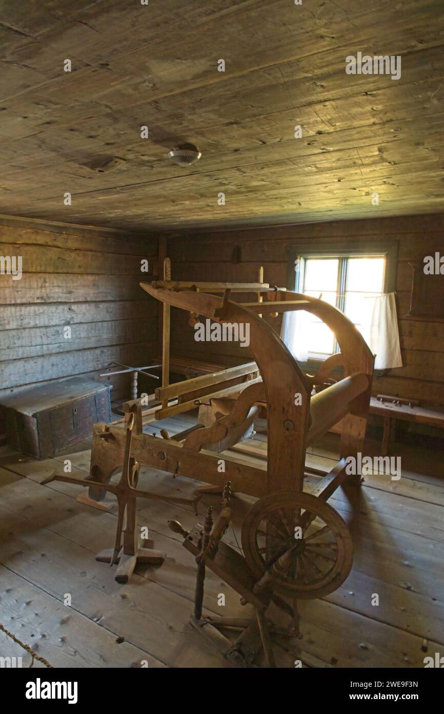 Vintage room with spinning wheel, loom, chest and window in old rural ...