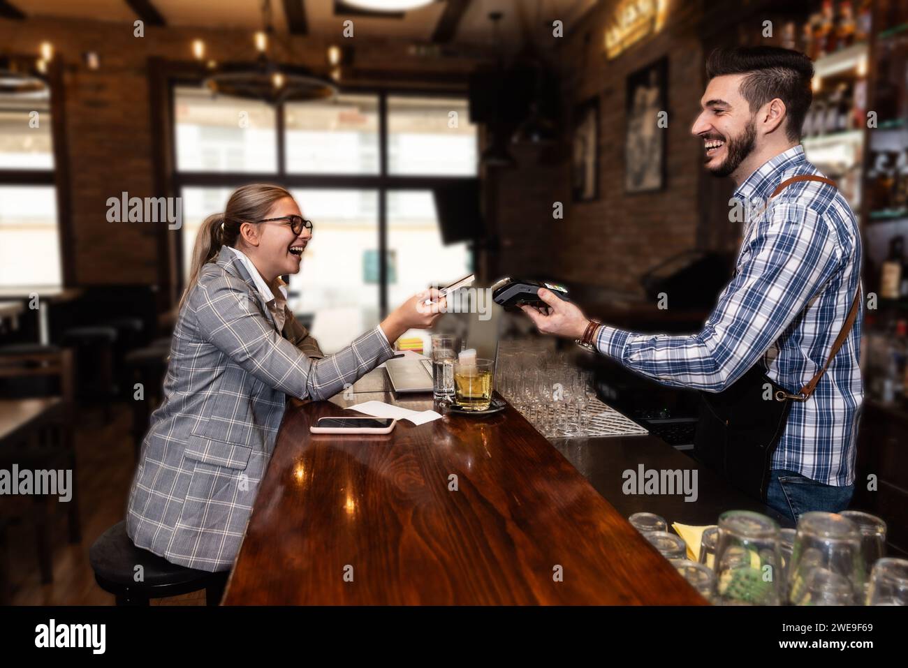 Business woman paying with a contactless debit credit card in a ...
