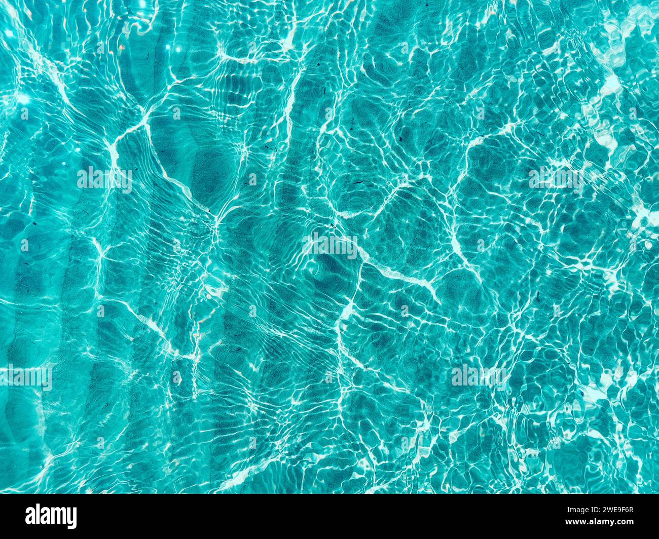 Water ripple over sandy beach. Transparent blue colored clear water ...