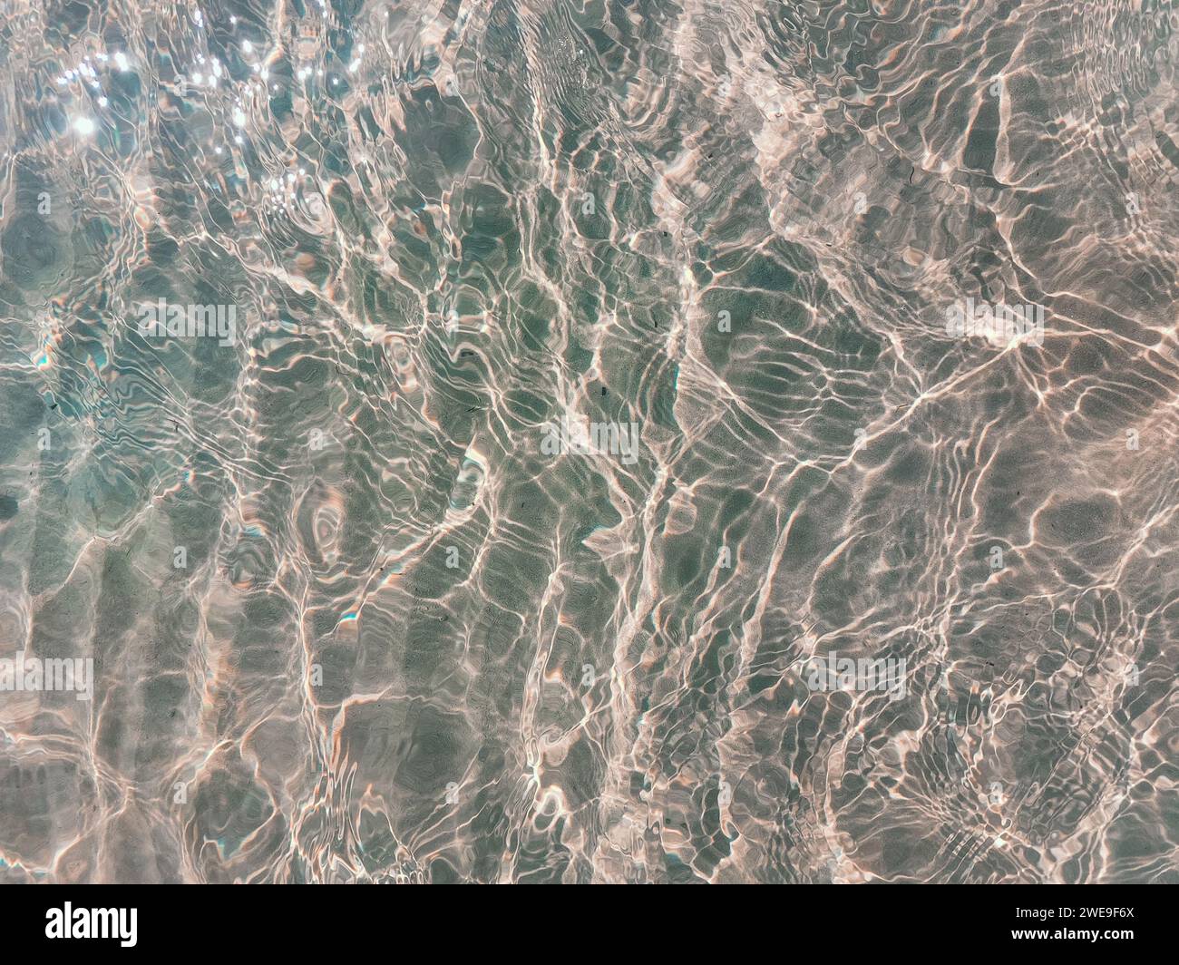 Water ripple over sandy beach. Transparent blue colored clear water ...
