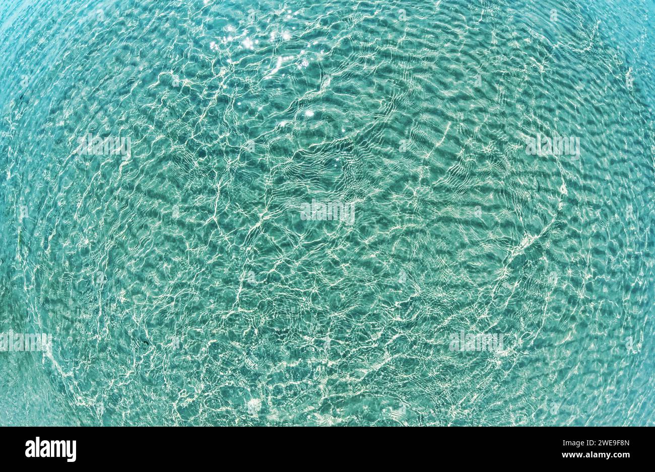 Water ripple over sandy beach. Transparent blue colored clear water ...