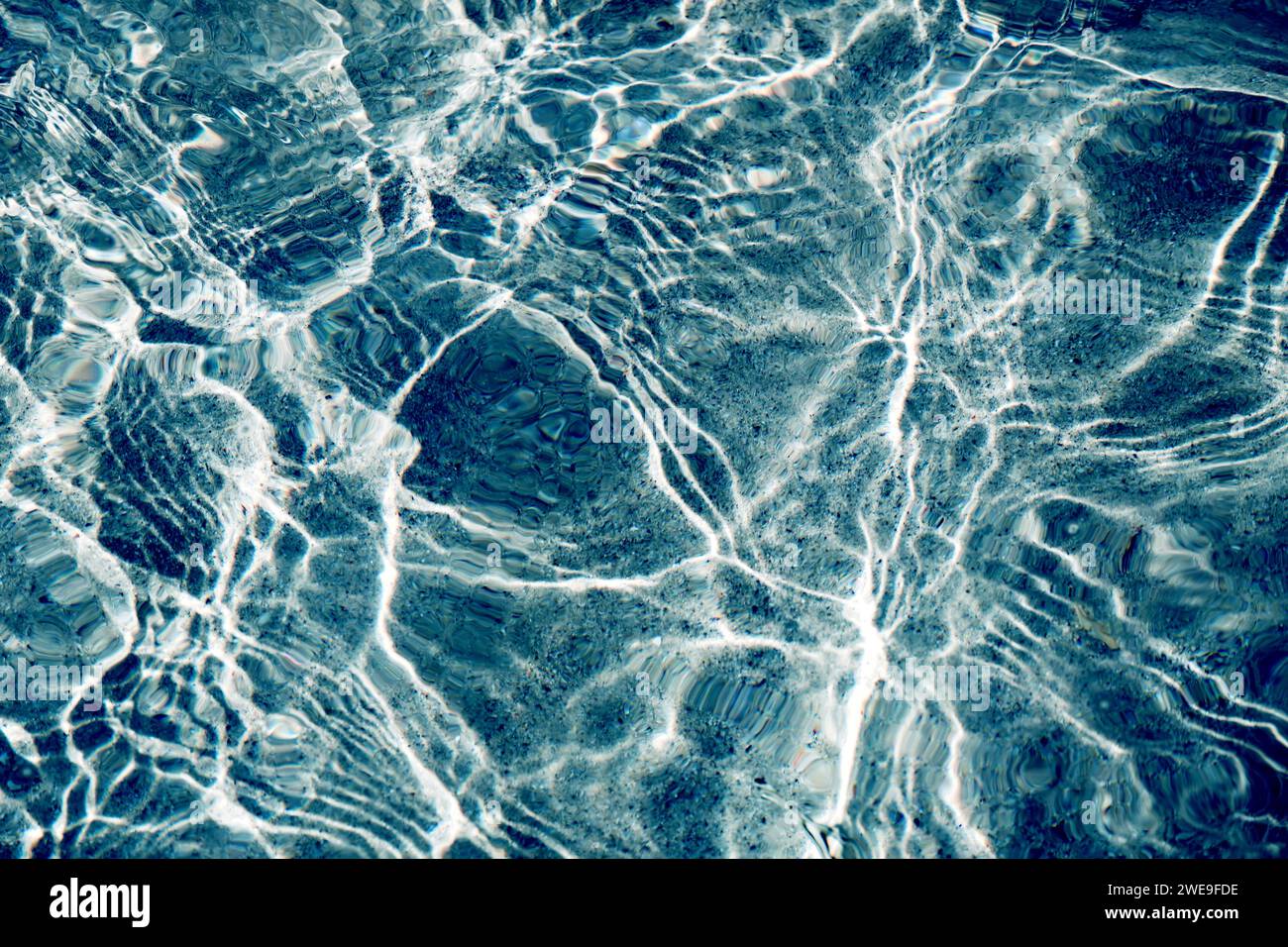 Water ripple over sandy beach. Transparent blue colored clear water ...