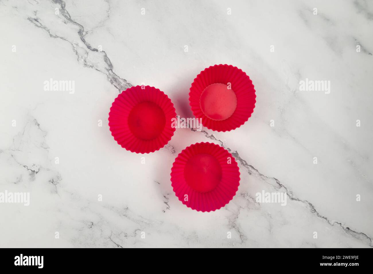 Top view of silicone cupcakes cases on white marble background. Muffins ...