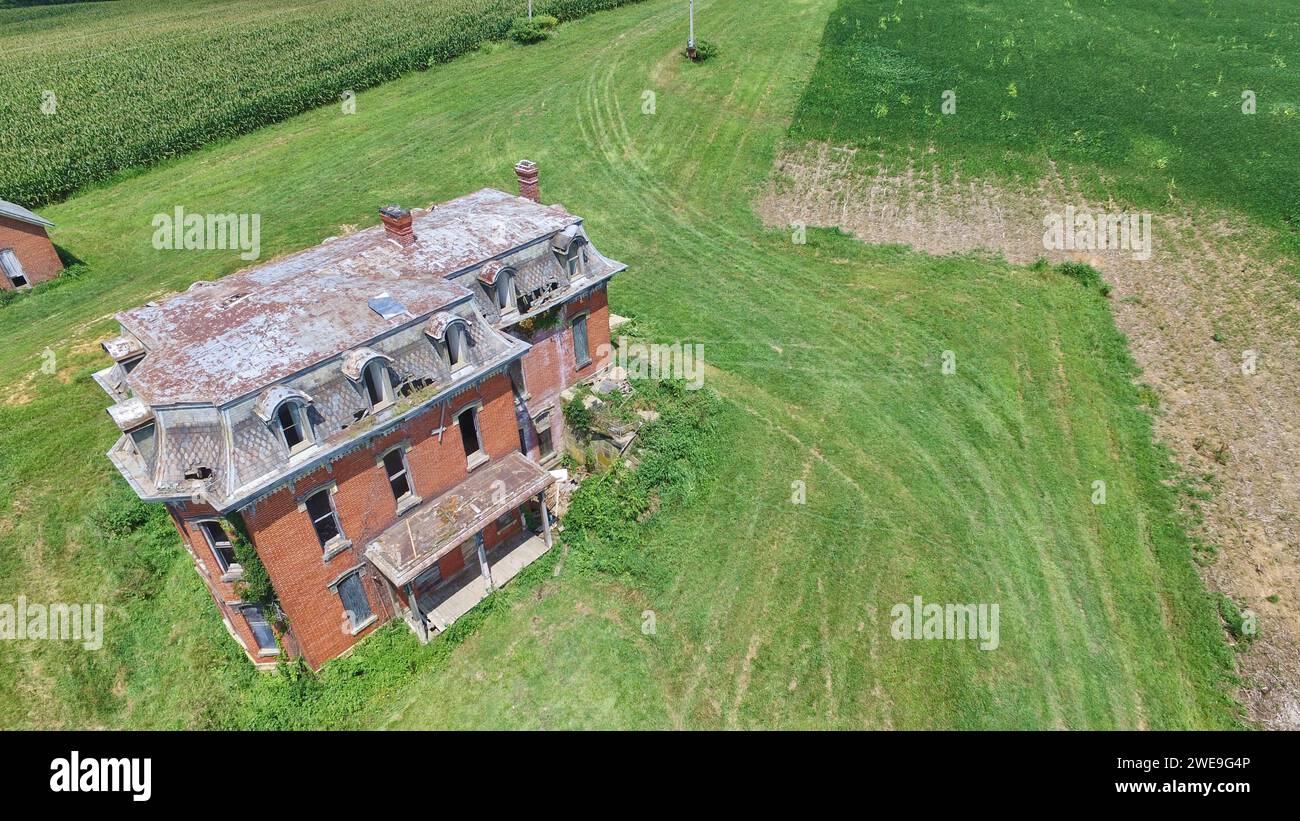 Aerial View of Abandoned Red Brick Mansion Amidst Green Fields Stock ...