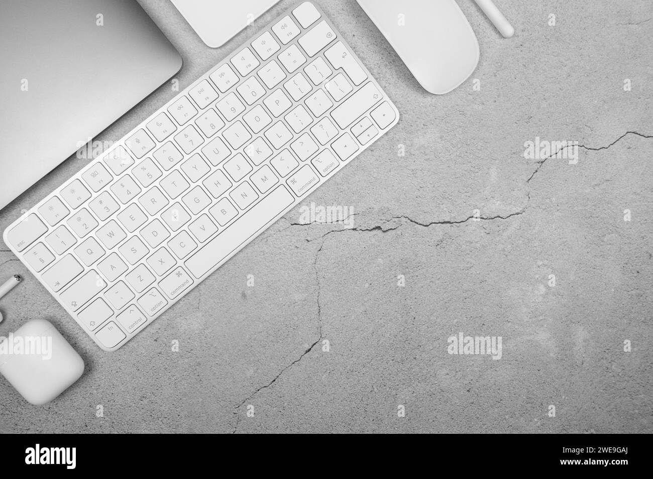 Top view of laptop computer, white keyboard, mouse, touchpad, earphones ...