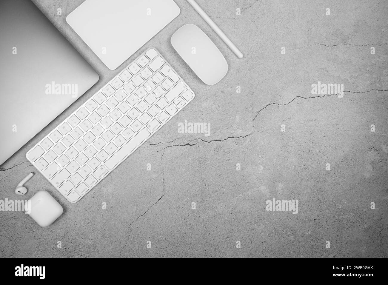 Top view of laptop computer, white keyboard, mouse, touchpad, earphones ...