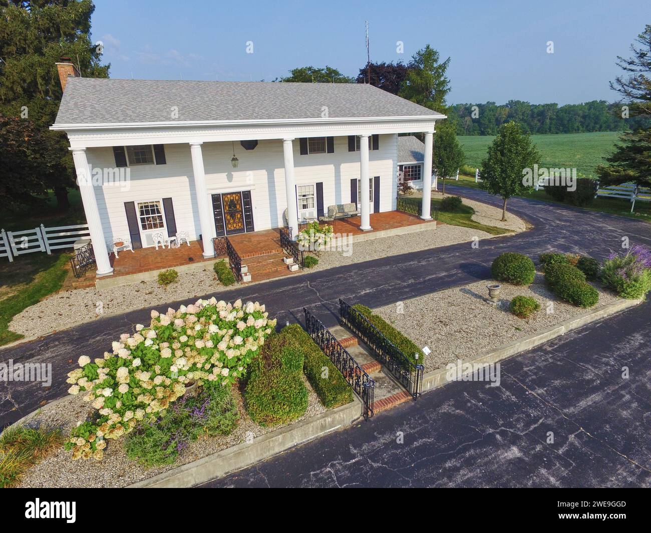 Aerial View of Colonial House with Manicured Lawn and Gravel Driveway ...