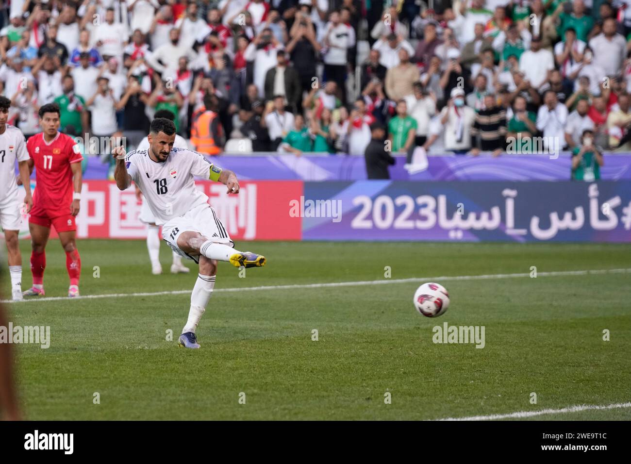 Iraq's Aymen Hussein scores his side's third goal from a penalty spot ...