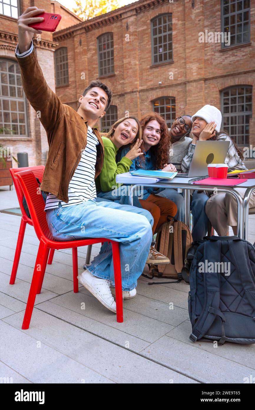 Vertical portrait Happy multiethnic group of young friends take a selfie together on campus ...