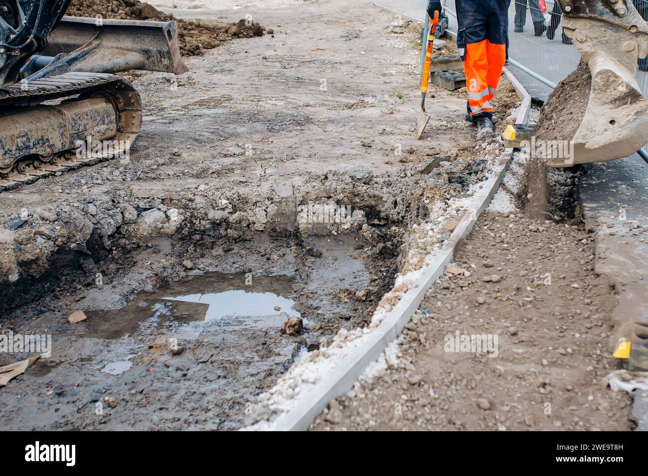 A new footpath is under construction as builders bring stone, levelling ...