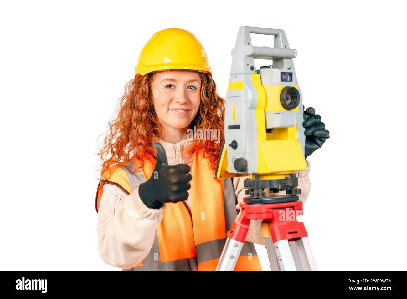 Red hair Woman in yellow hardhat and orange ppe surveyor working with ...