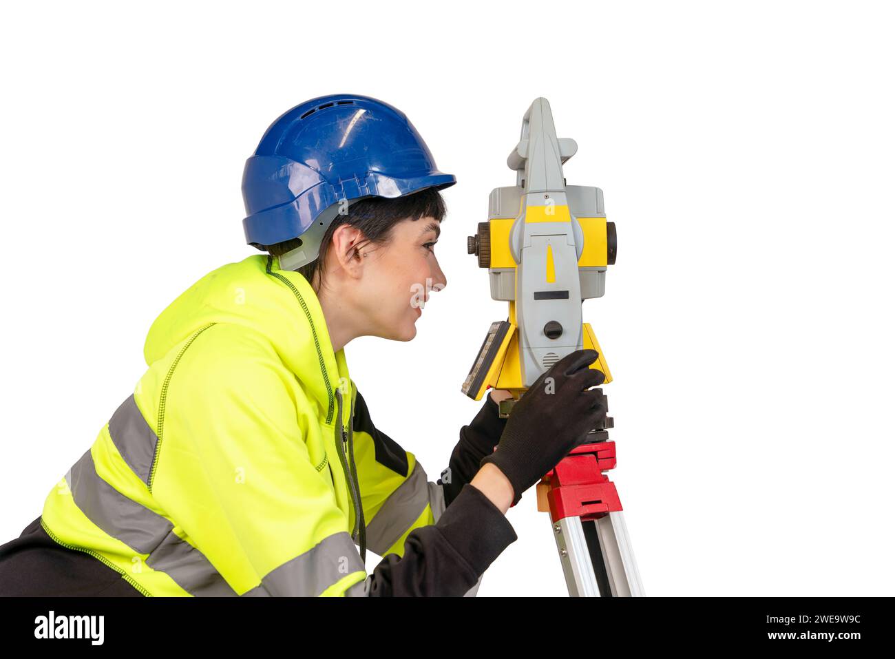 Woman in blue hard hat and yellow protective clothes land surveyor ...