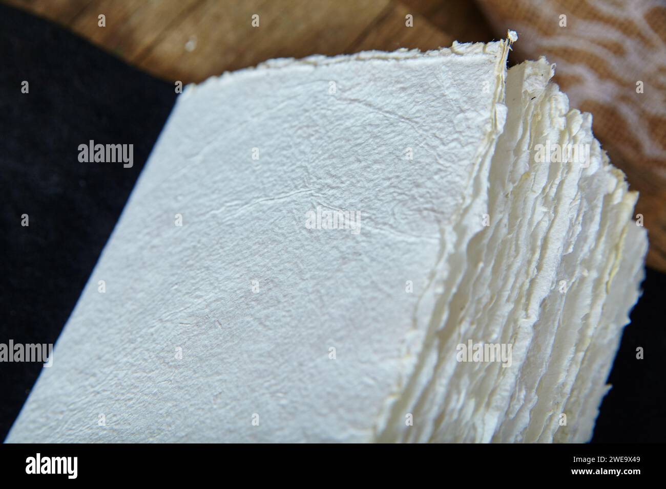 Textured Paper Stack with Deckle Edges and Rustic Backdrop Stock Photo ...