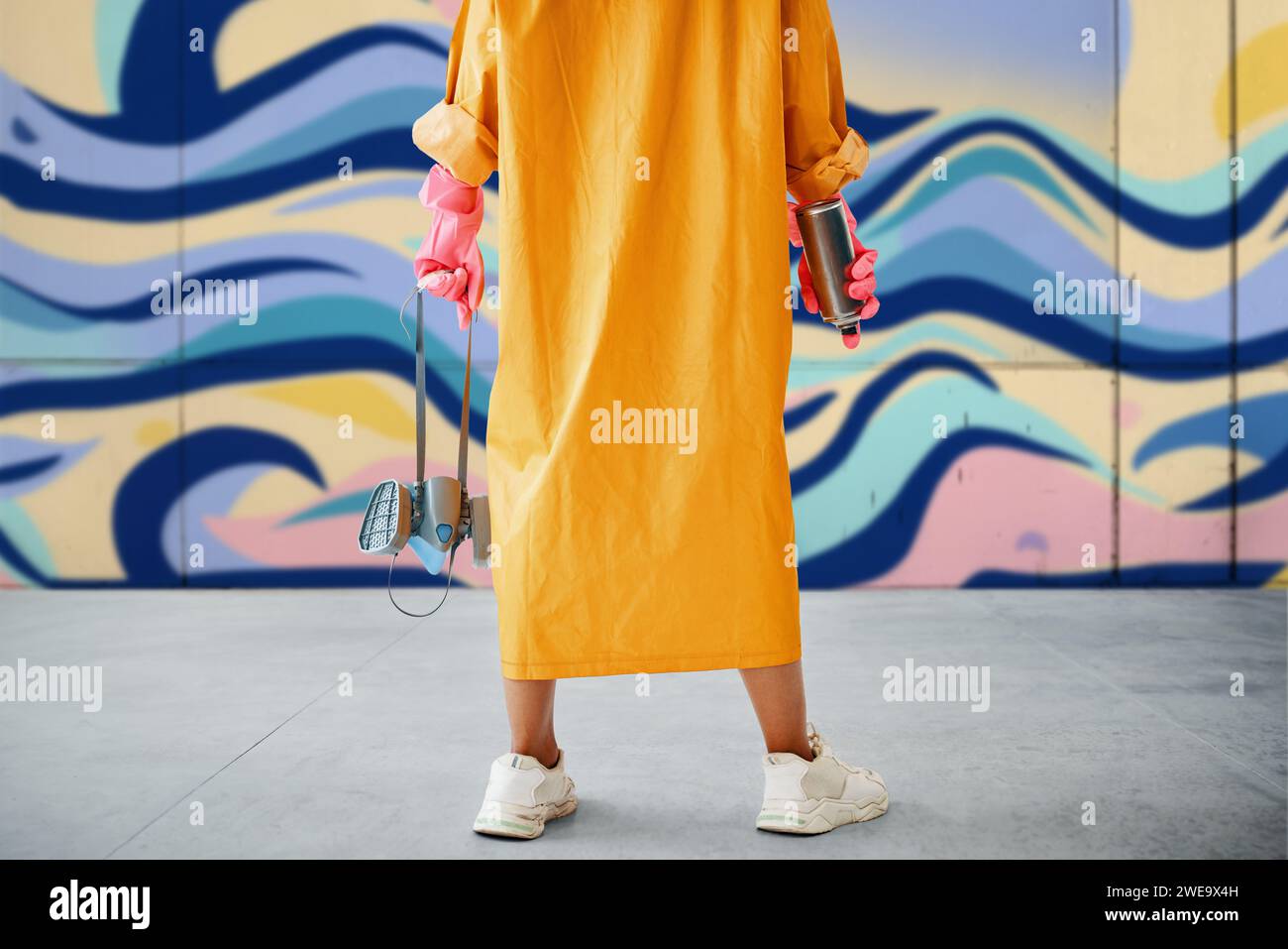 Cropped image of street artist with spray paint can and respirator mask ...