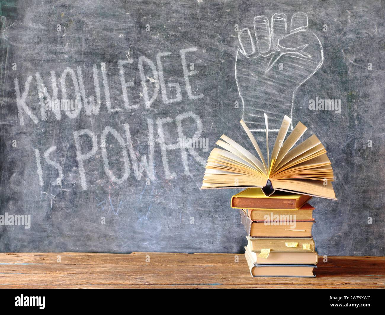 knowledge is power, books and blackboard with drawing of a fist power ...