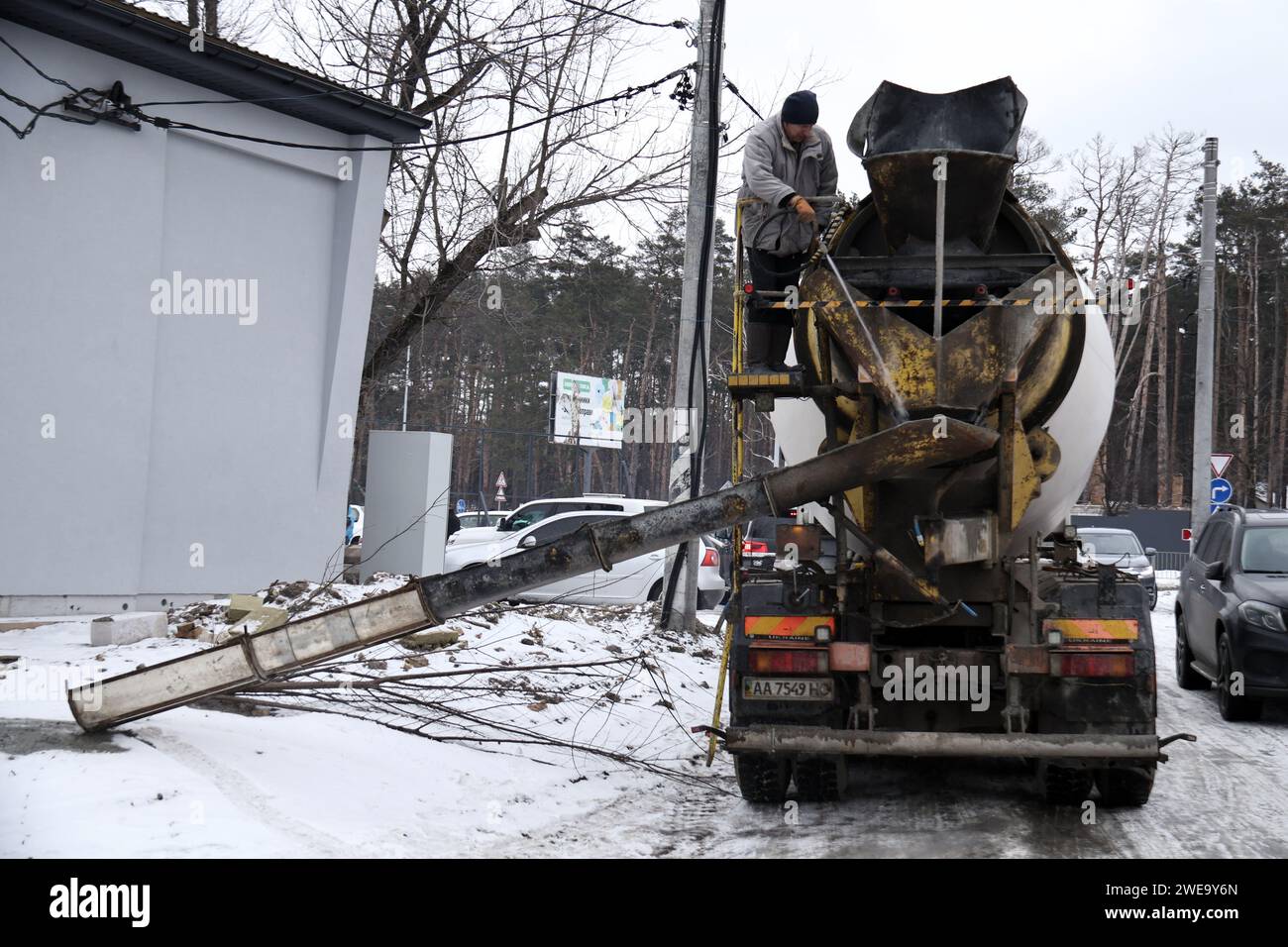 IRPIN, UKRAINE - JANUARY 23, 2024 - A builder operates a concrete mixer ...
