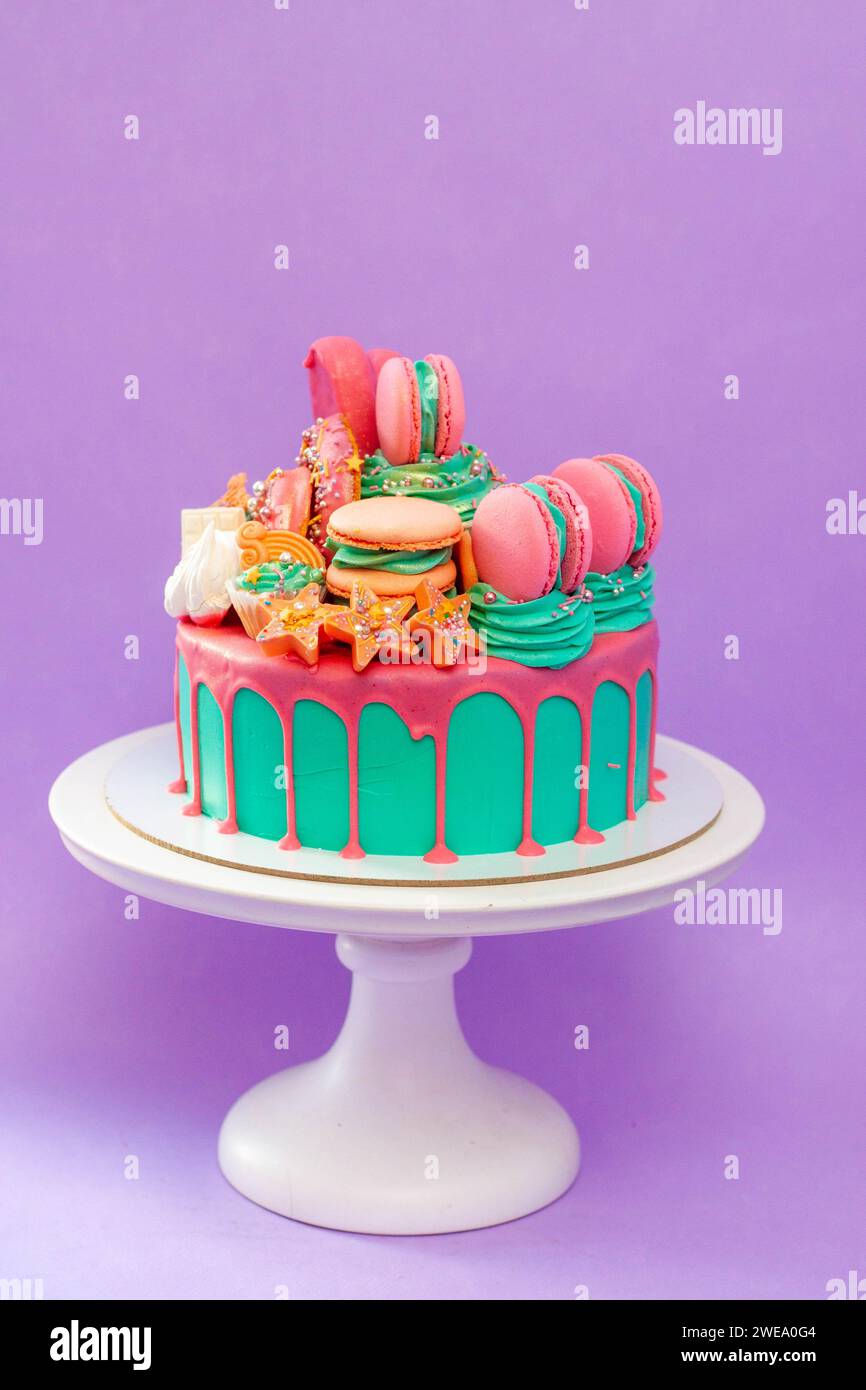 Birthday cake with turquoise frosting and pink birthday decorations ...