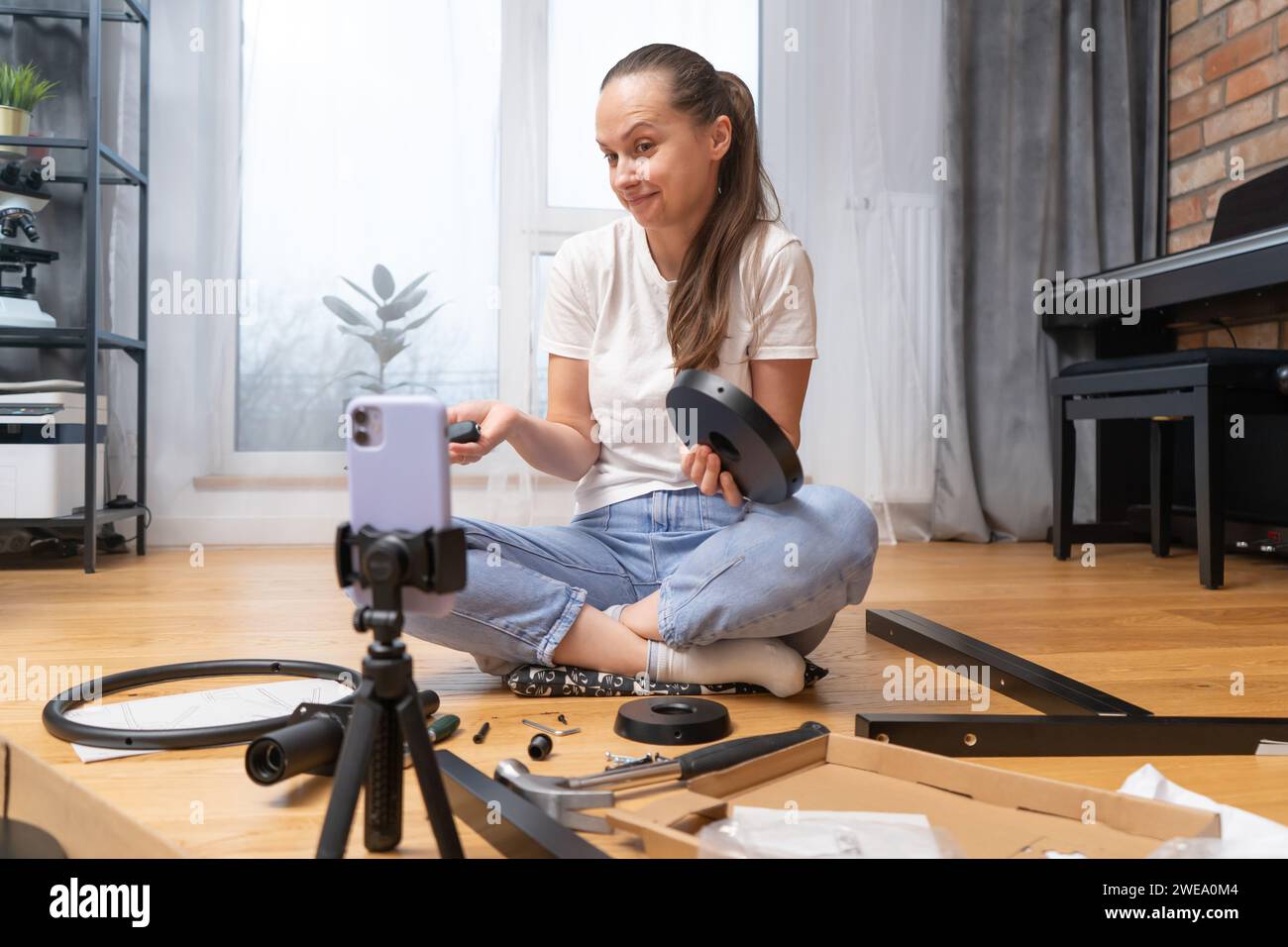 A girl does not understand how to assemble furniture and receives ...